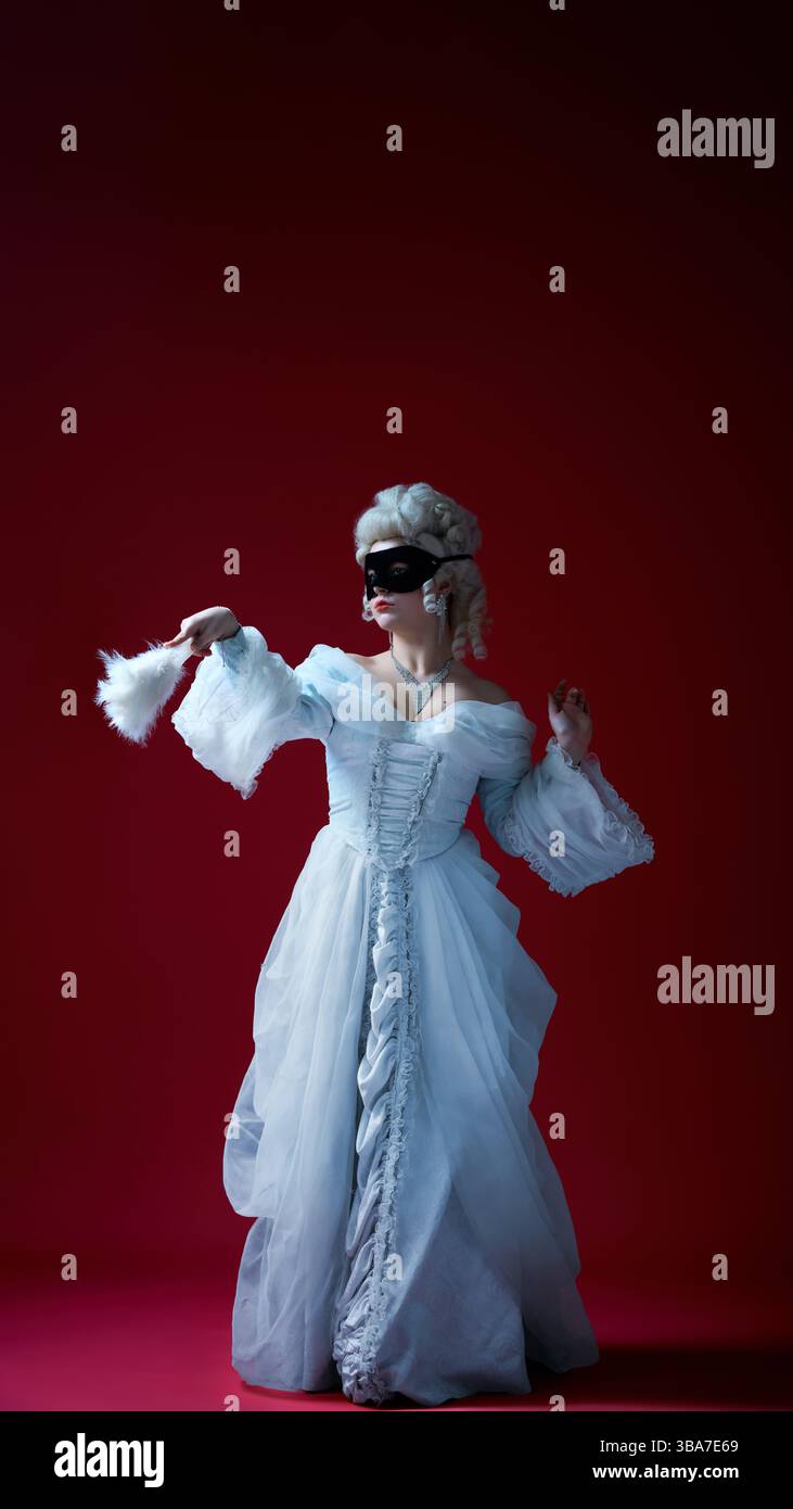 Court confidence. Lady in full-length vintage gown standing tall with ...