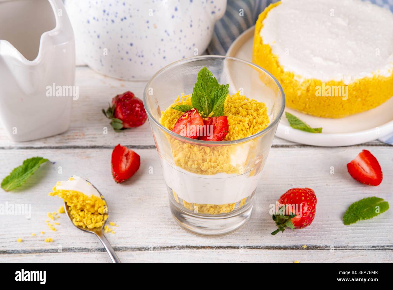 Classic cheesecake in glass, with fresh strawberry and golden cookie ...
