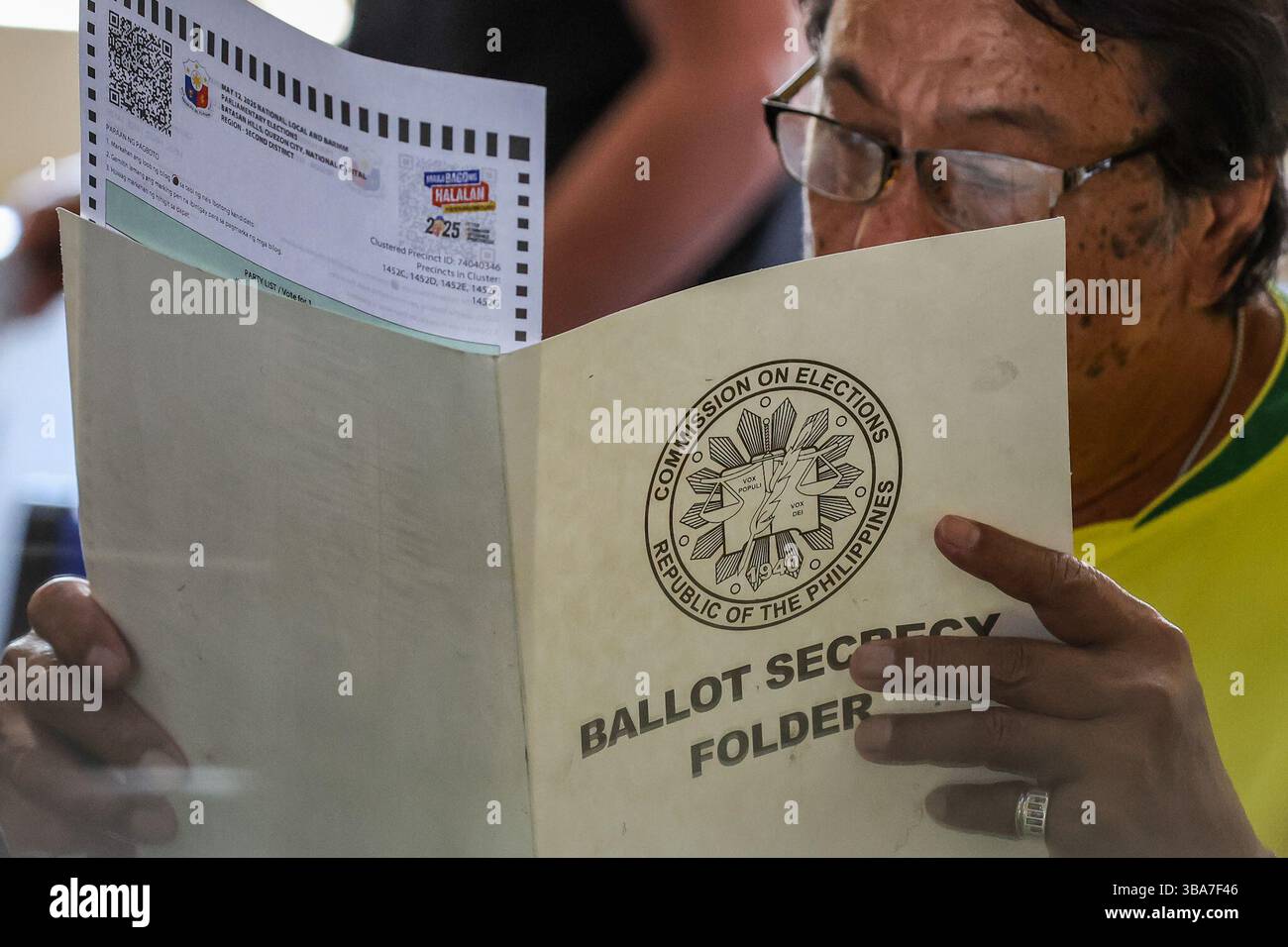 Quezon City, Philippines. 12th May, 2025. A man casts his ballot at a ...