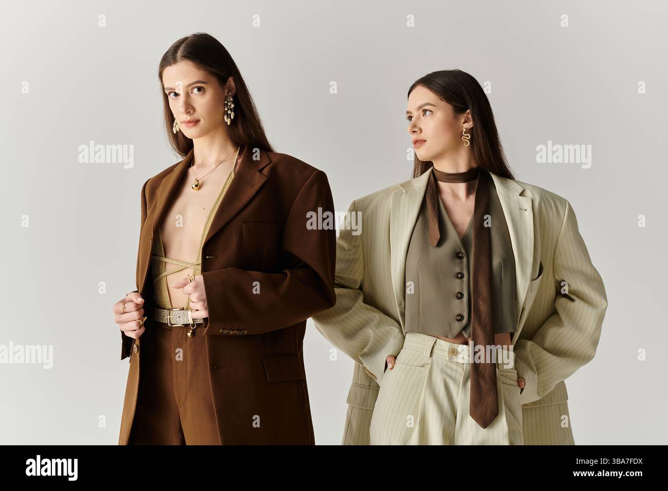 Twin sisters display their unique styles through elegant suits in a ...