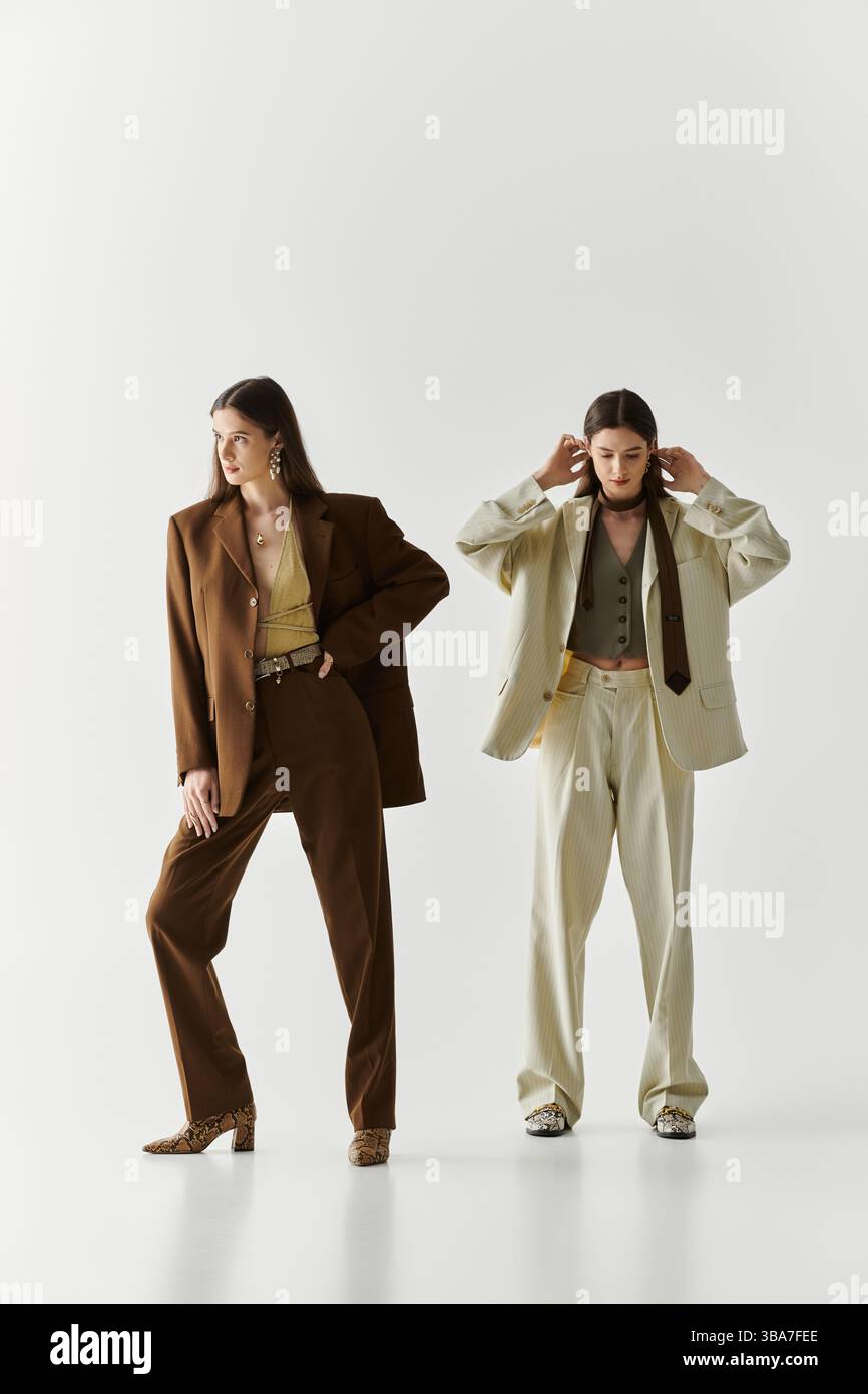 Twin sisters elegantly pose, highlighting their distinct styles in a ...