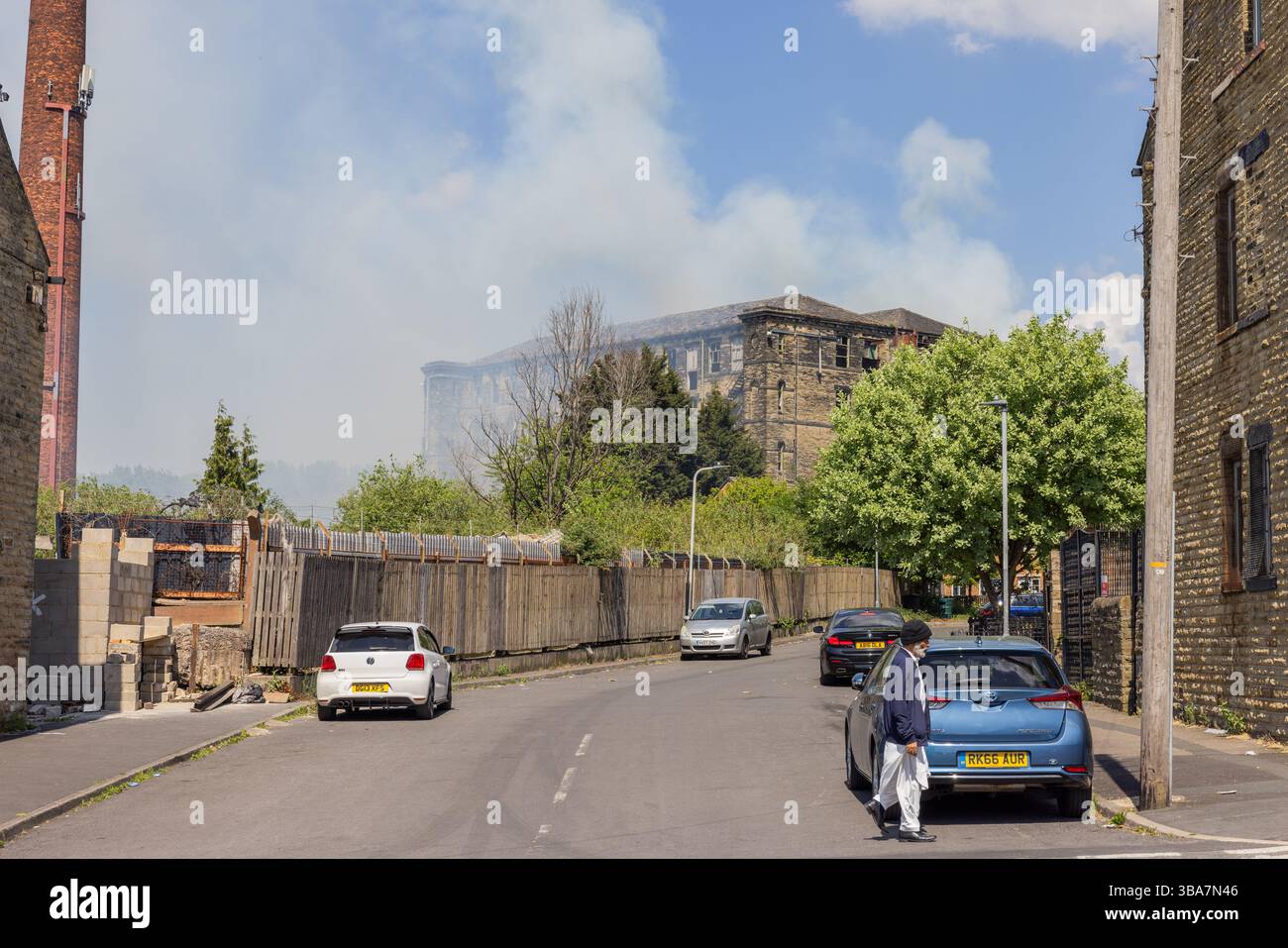 Bradford, UK. 12 MAY, 2025. View from nearby street as major fire ...