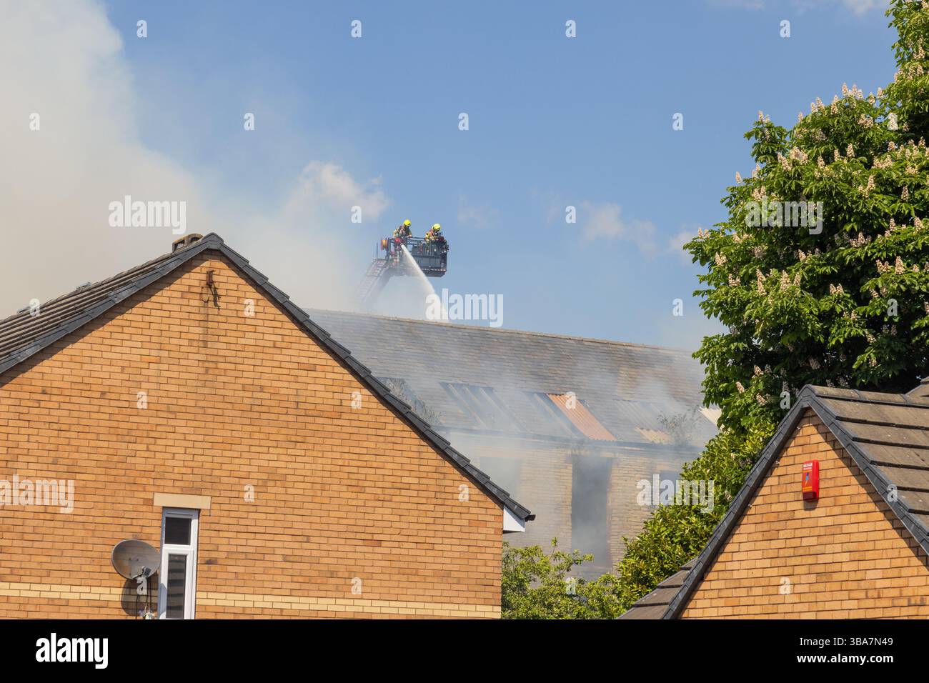 Bradford, UK. 12 MAY, 2025. View from nearby street as major fire ...