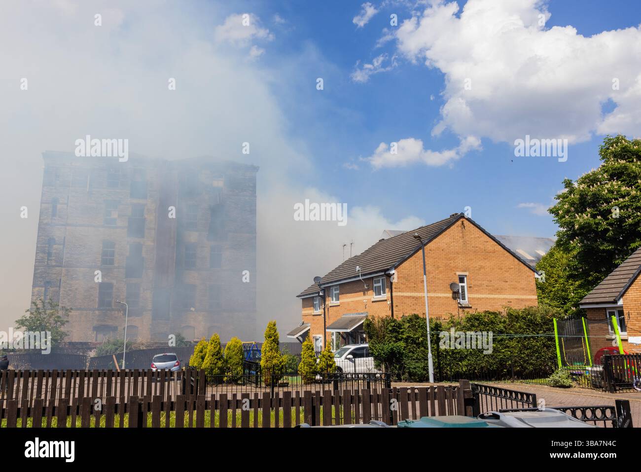 Bradford, UK. 12 MAY, 2025. View from nearby street as major fire ...
