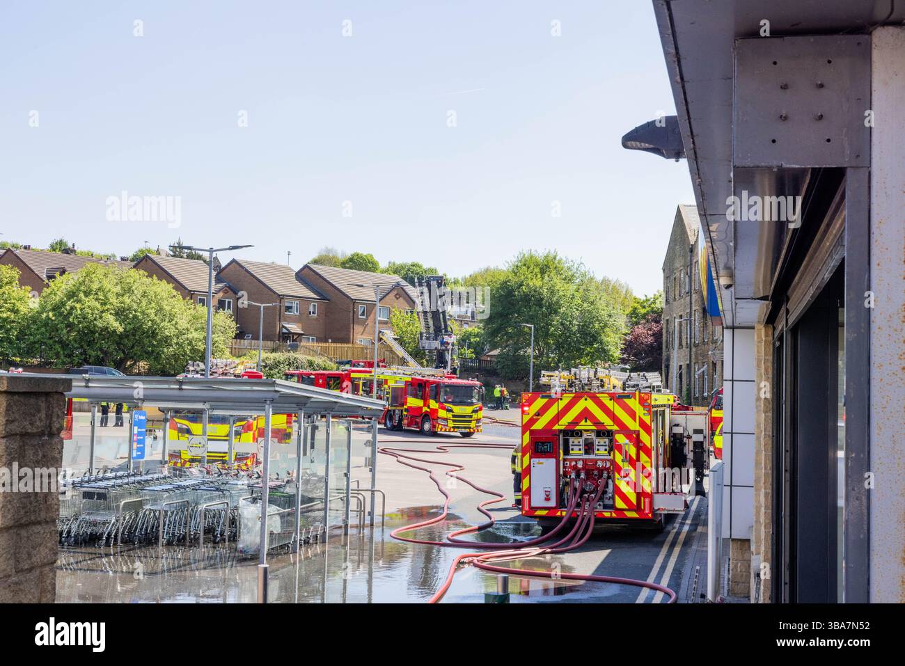 Bradford, UK. 12 MAY, 2025. Lidl carpark used for fire vehicles as fire ...