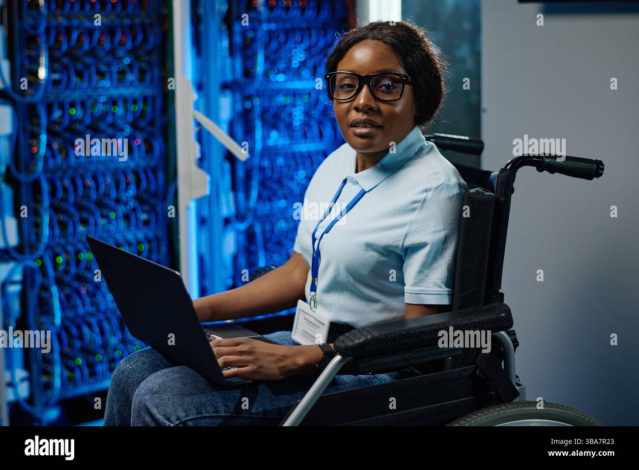 Portrait of African female IT engineer with disability sitting in ...