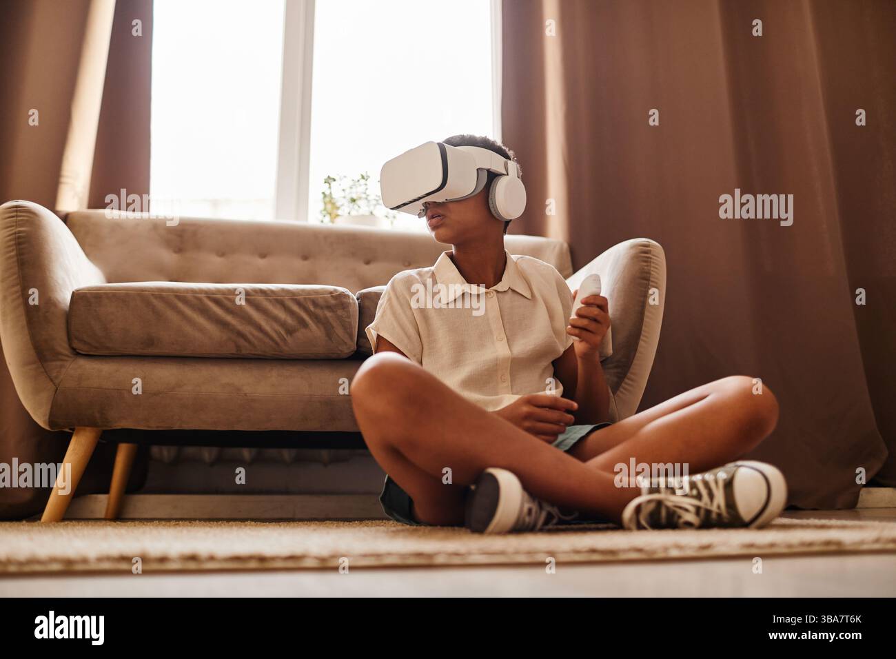 Full length portrait of African American girl playing VR game while ...