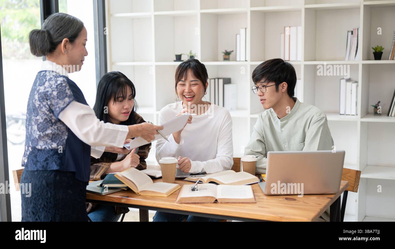 A group of cheerful Asian college students is enjoying studying math ...