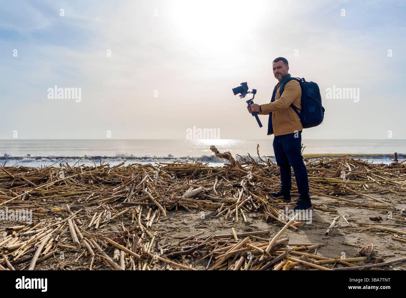 Camera Operator Filming Flood-Damaged Vegetation and Debris Washed ...