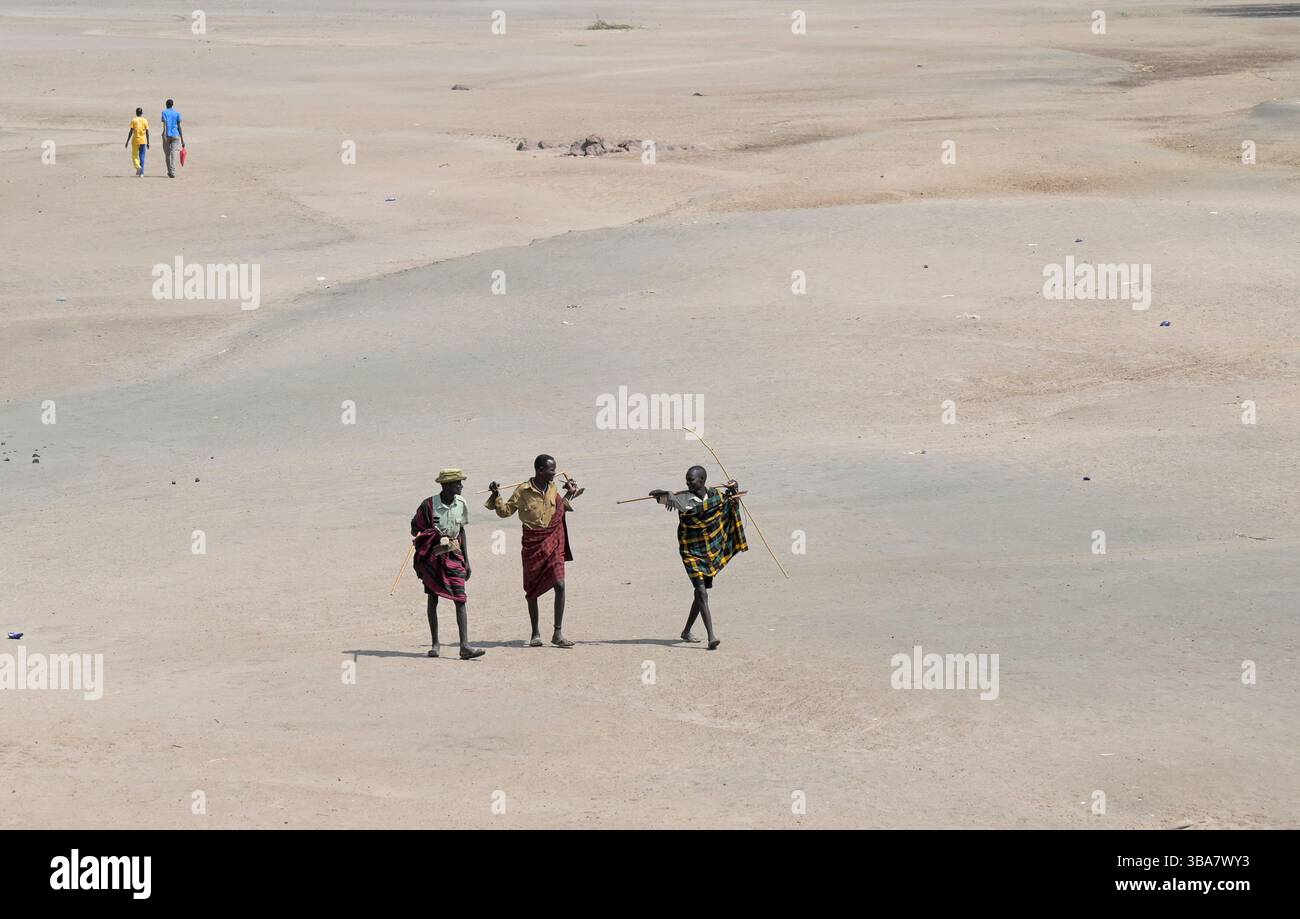 KENYA, Turkana, Kakuma, Turkana tribe men in empty Tarach river bed ...