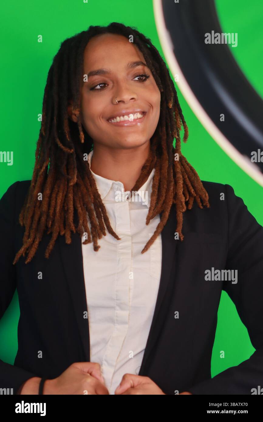 Black woman of Afro-Caribbean descent with dreadlocks dressed in formal business attire set ...