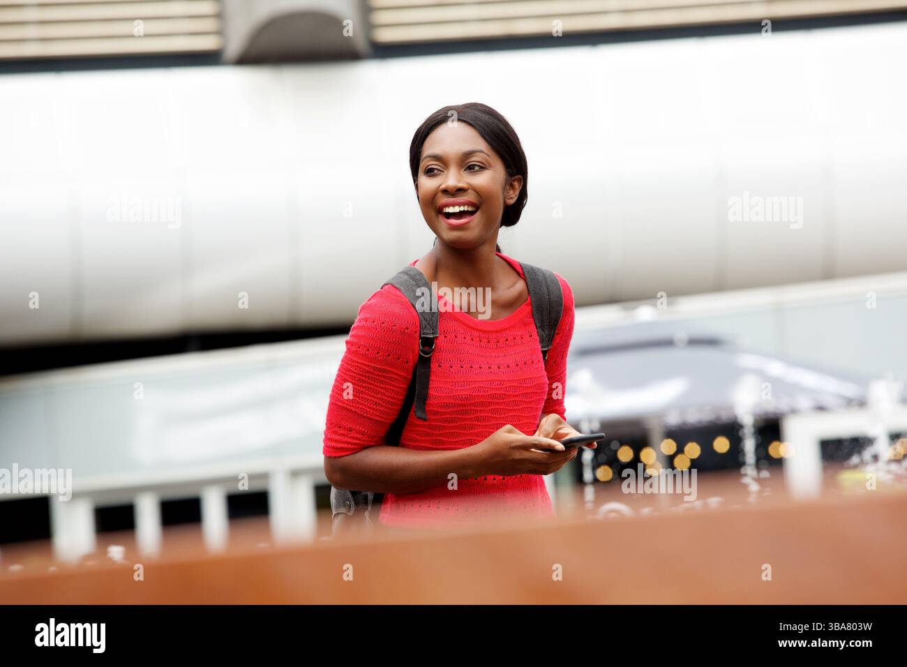 Black woman walking while texting in the city during daytime Stock ...