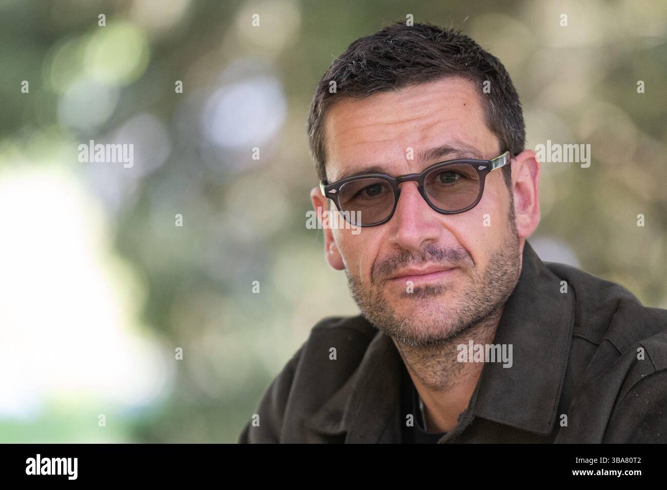 Berlin, Germany. 12th May, 2025. Michael Epp, actor, sits in a park on ...