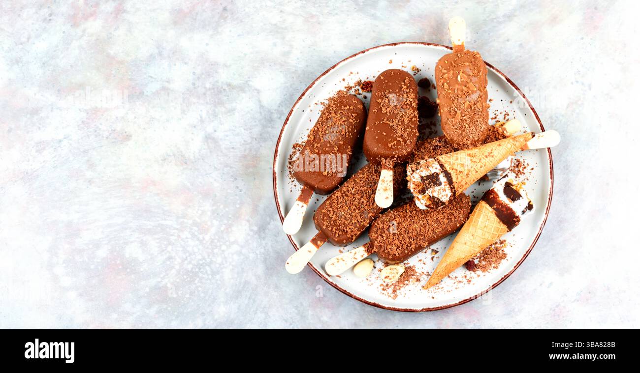 Chocolate ice cream bars on a stick. Refreshing summer food. Space for ...