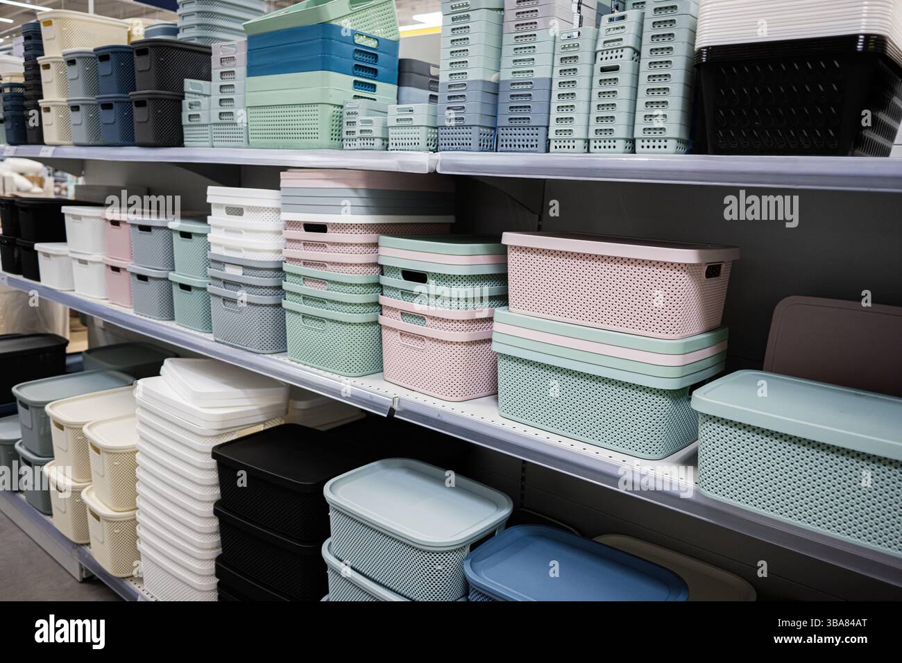 Organized display of various storage boxes in different colors and ...