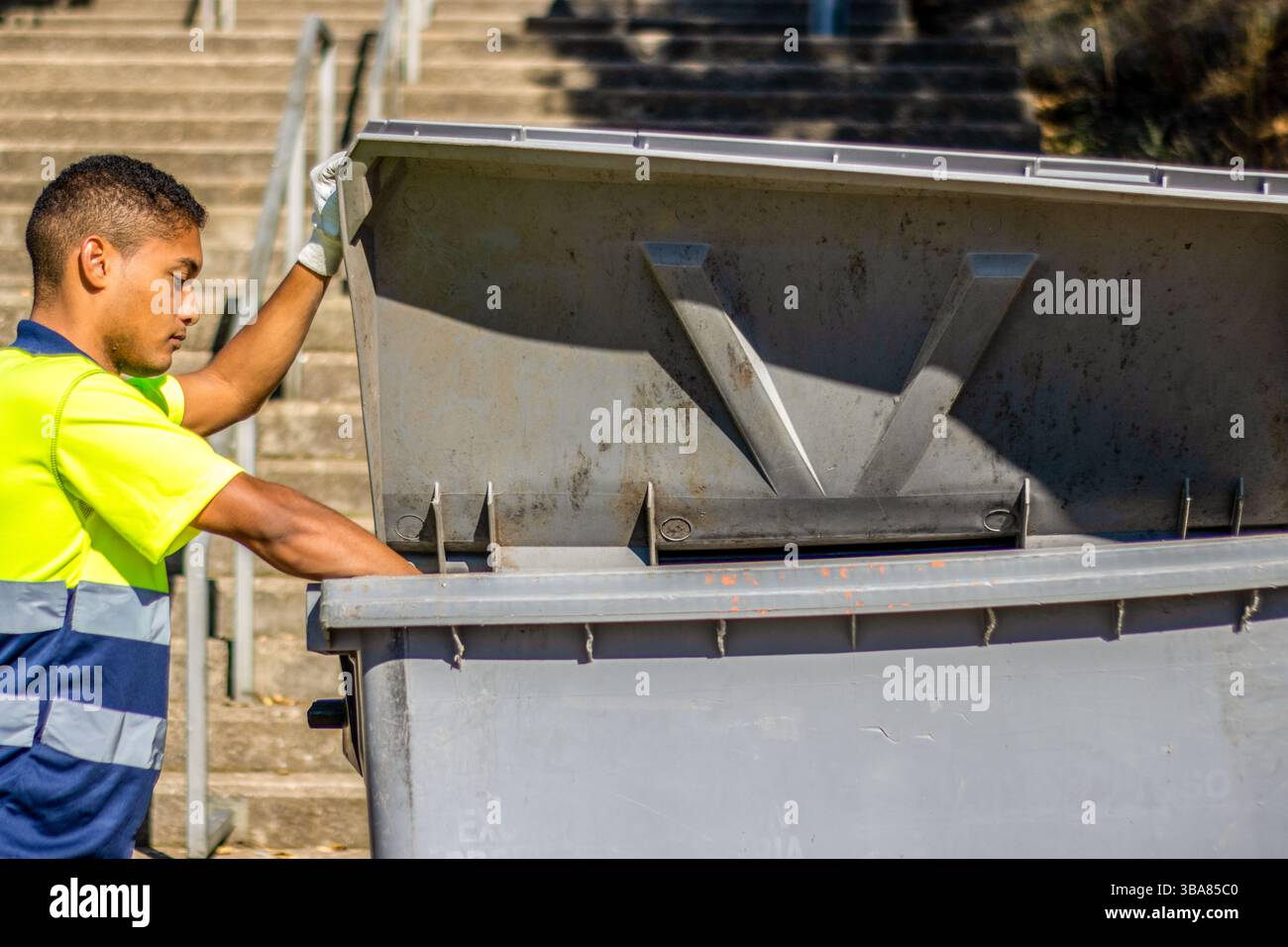 Man putting garbage bag in the trash can. Person putting garbage bags ...