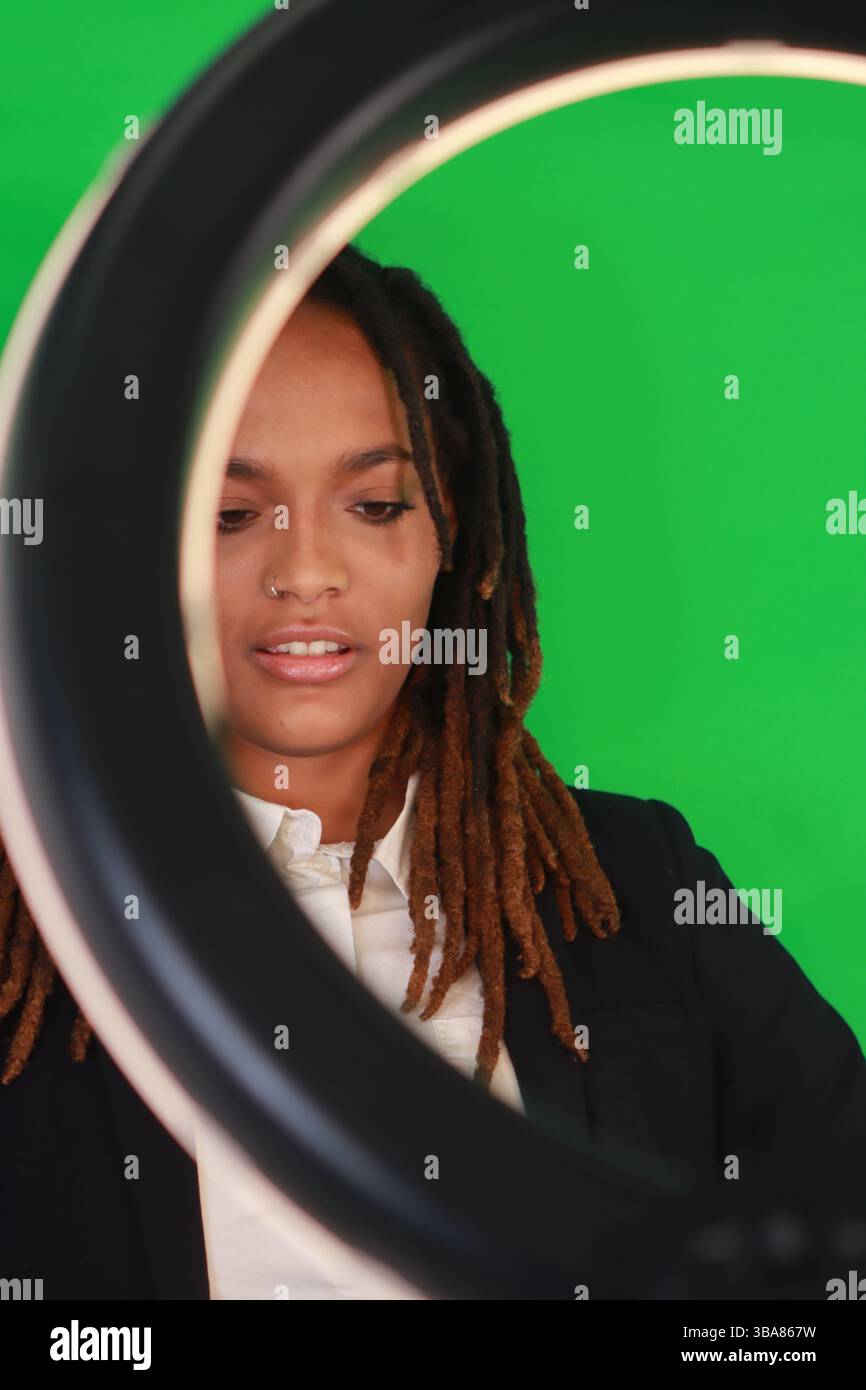 Black woman of Afro-Caribbean descent with dreadlocks dressed in formal business attire set ...