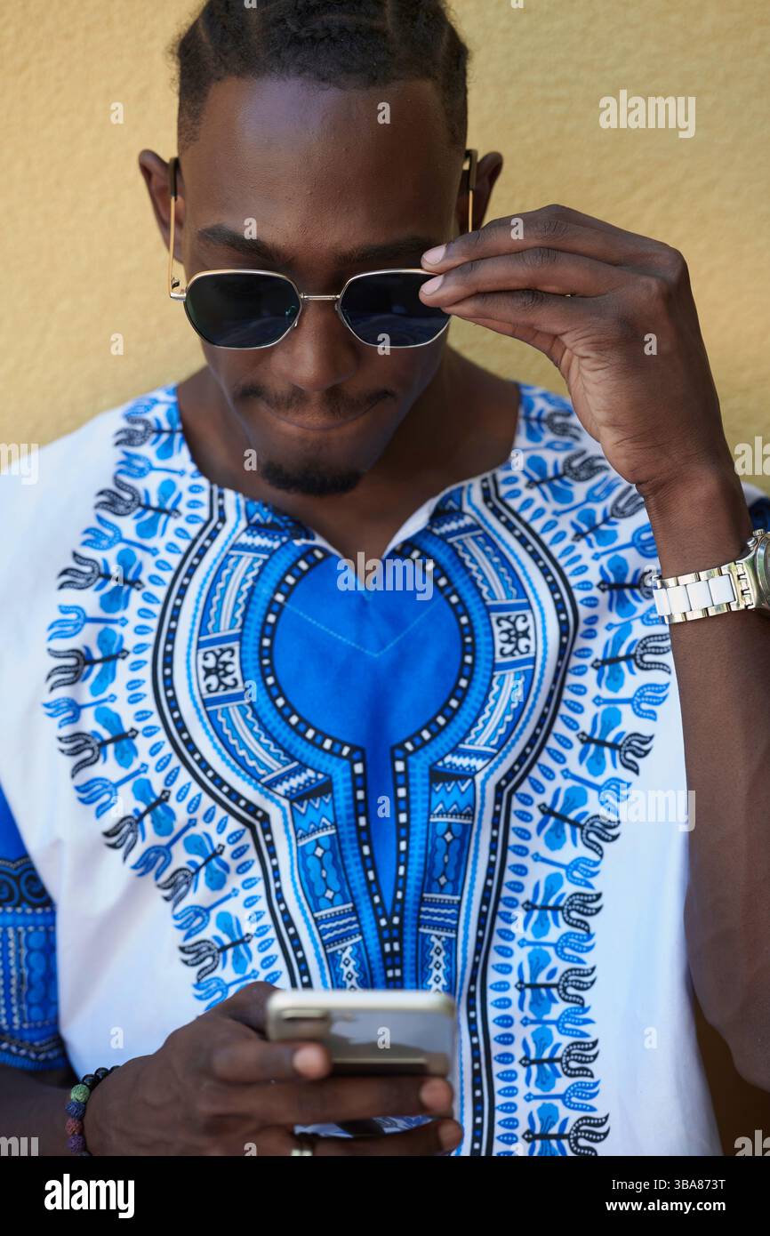 Native Sudan black african man using smart phone and wearing ...