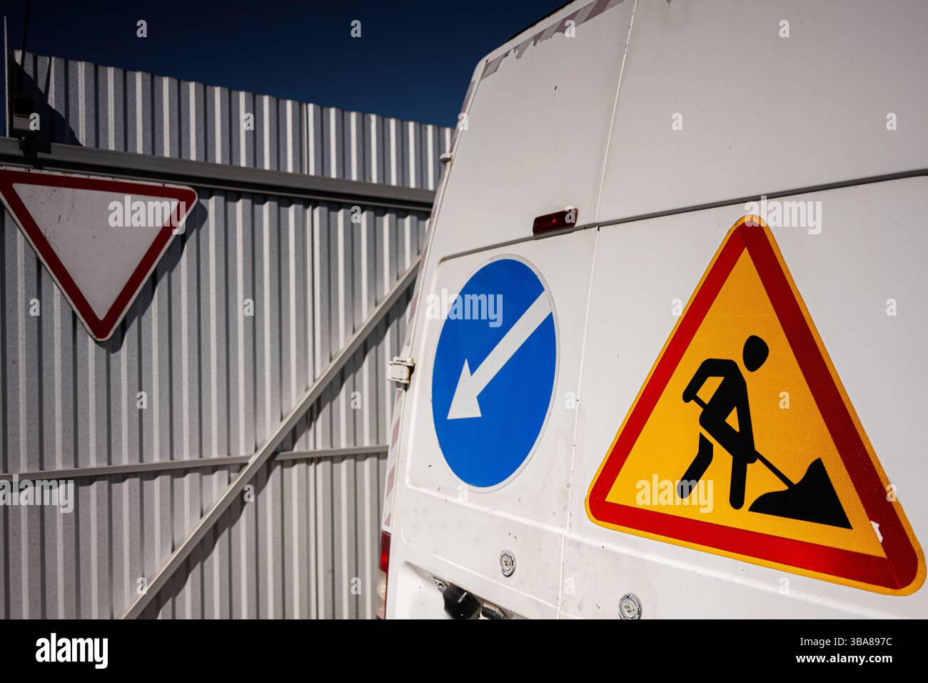 Rear view of a vehicle displaying traffic signs related to construction ...