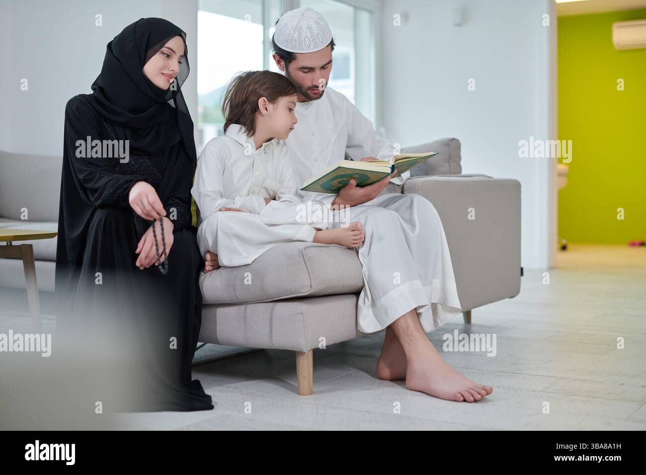 Young muslim family reading Quran during Ramadan. Parents and son ...