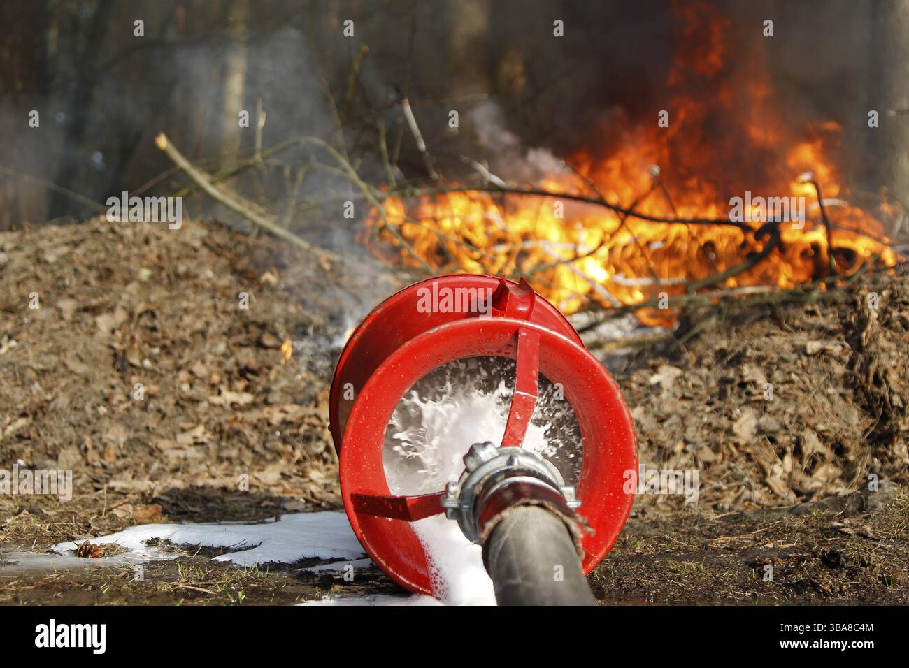 The fireman holds a fire hose in his hand to extinguish a fire. Fire ...