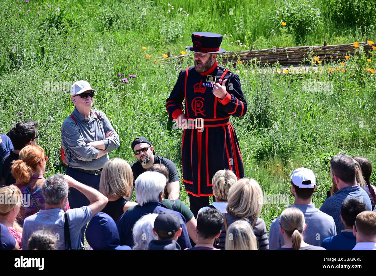 A Yeoman Warder (Beefeater) at the Tower of London explaining its ...