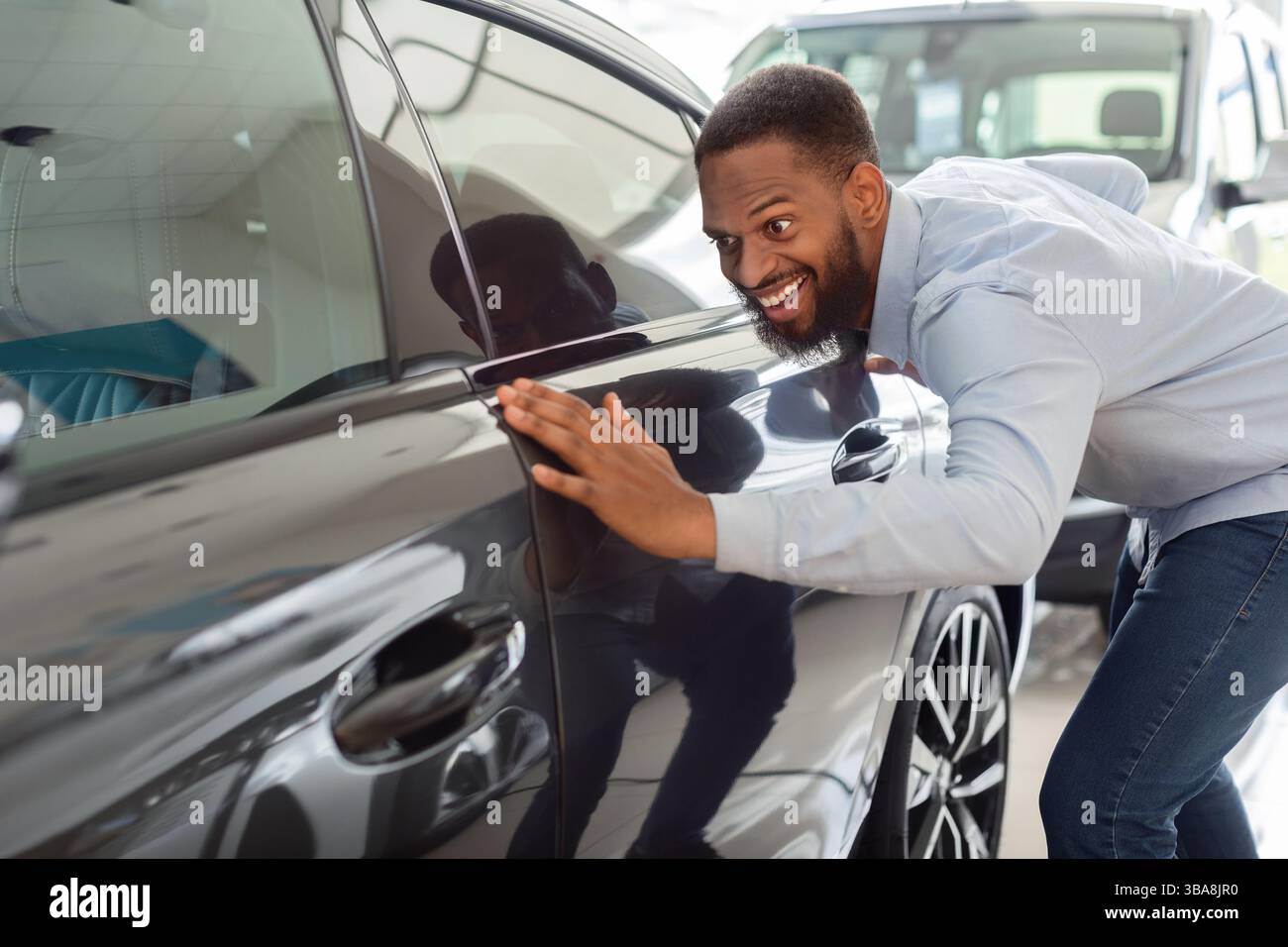 Happy Owner. Excited Black Man Touching His New Car In Showroom After ...