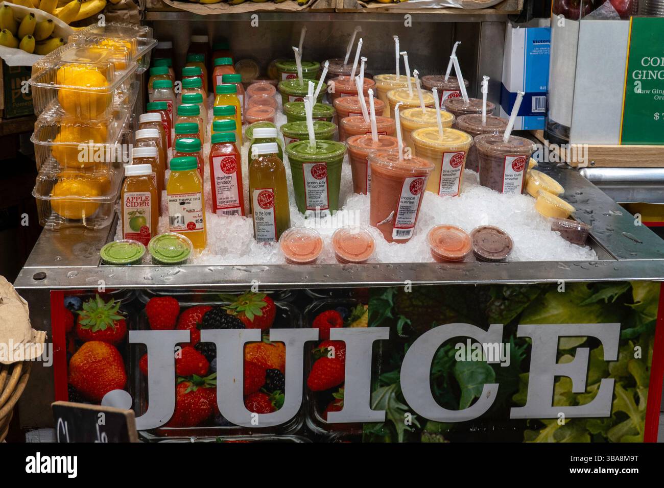 Pressed juices for sale at Eli Zabar produce stand in the food market ...