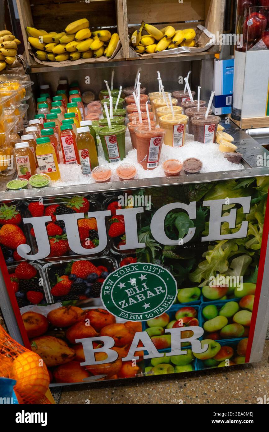 Pressed juices for sale at Eli Zabar produce stand in the food market ...