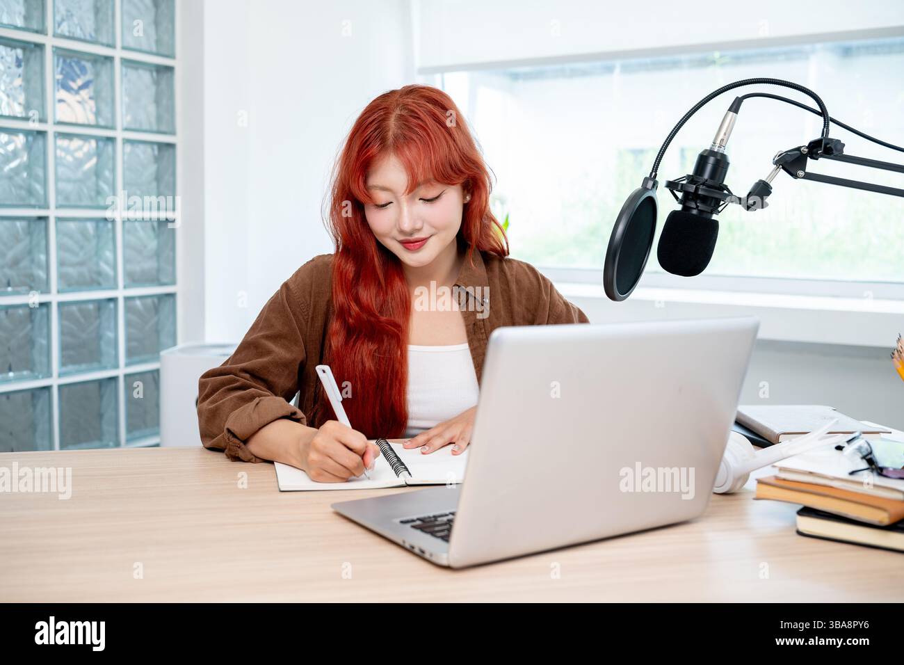 A charming and positive Asian female radio host or journalist with red ...