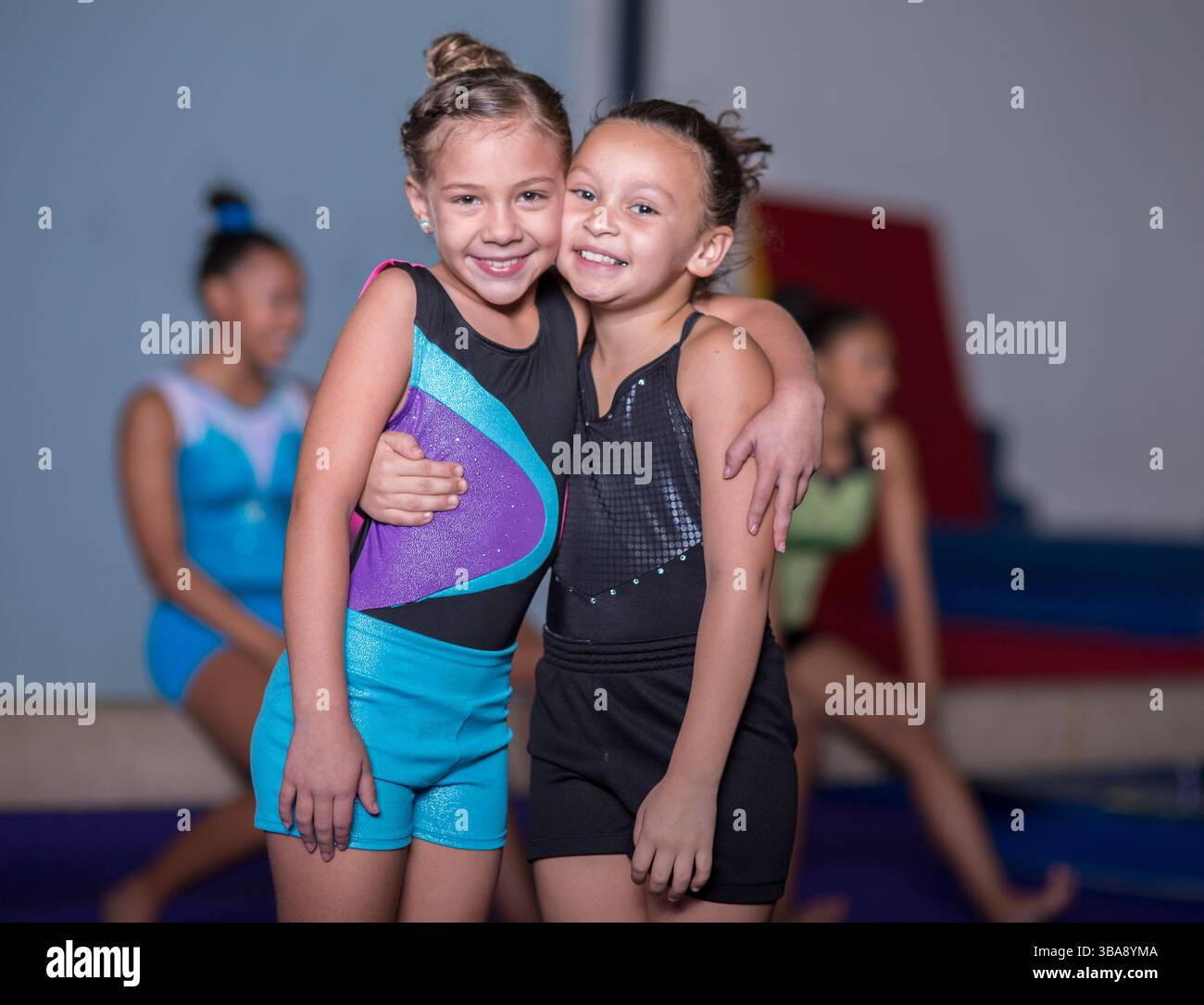 Two young Latina gymnasts smiling and hugging each other Stock Photo ...