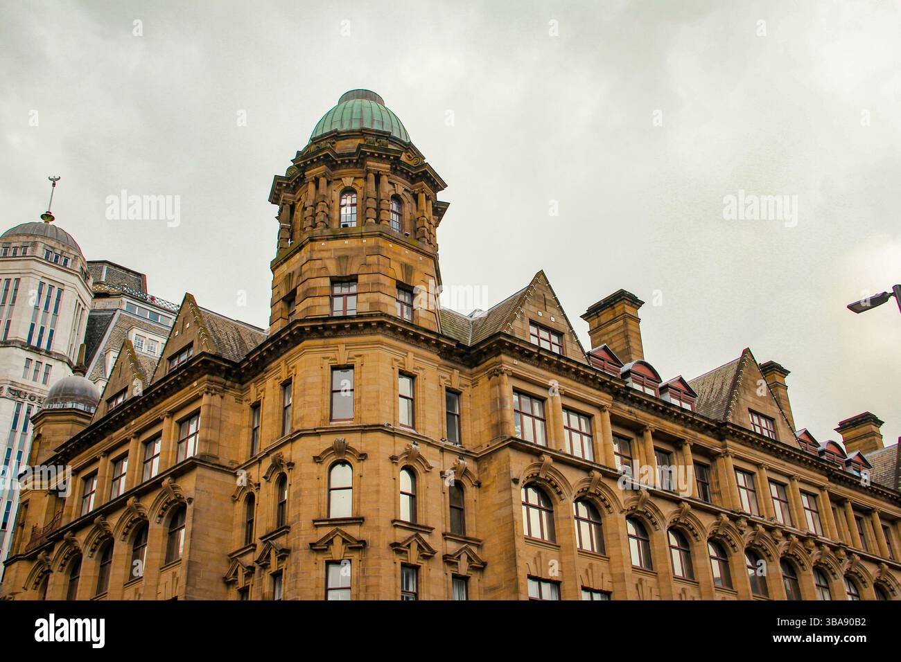 Deansgate, Ornate stone building with green dome roofs and classic ...