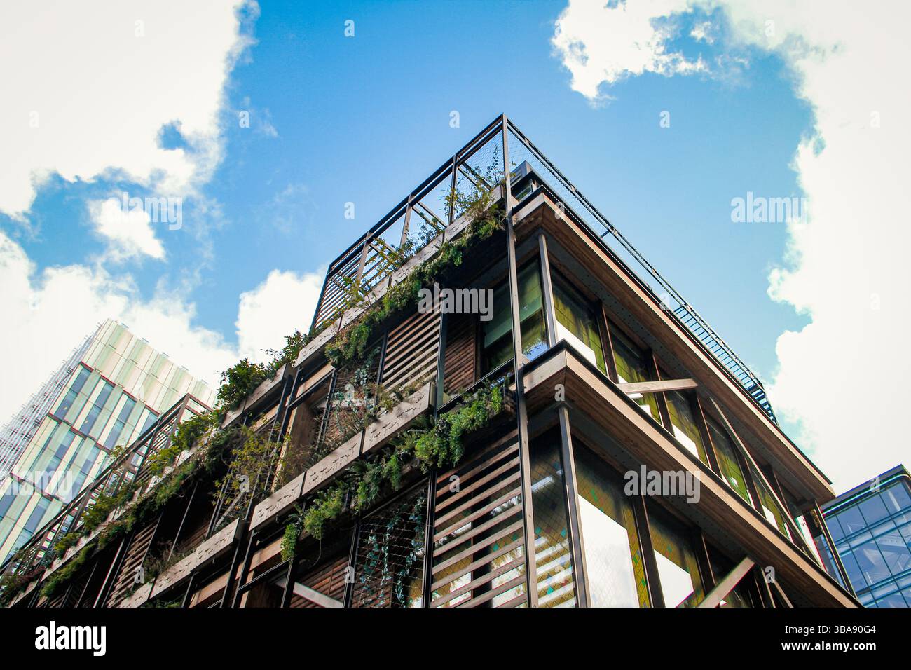 Deansgate: Green-framed glass buildings with exposed pipes and steel ...