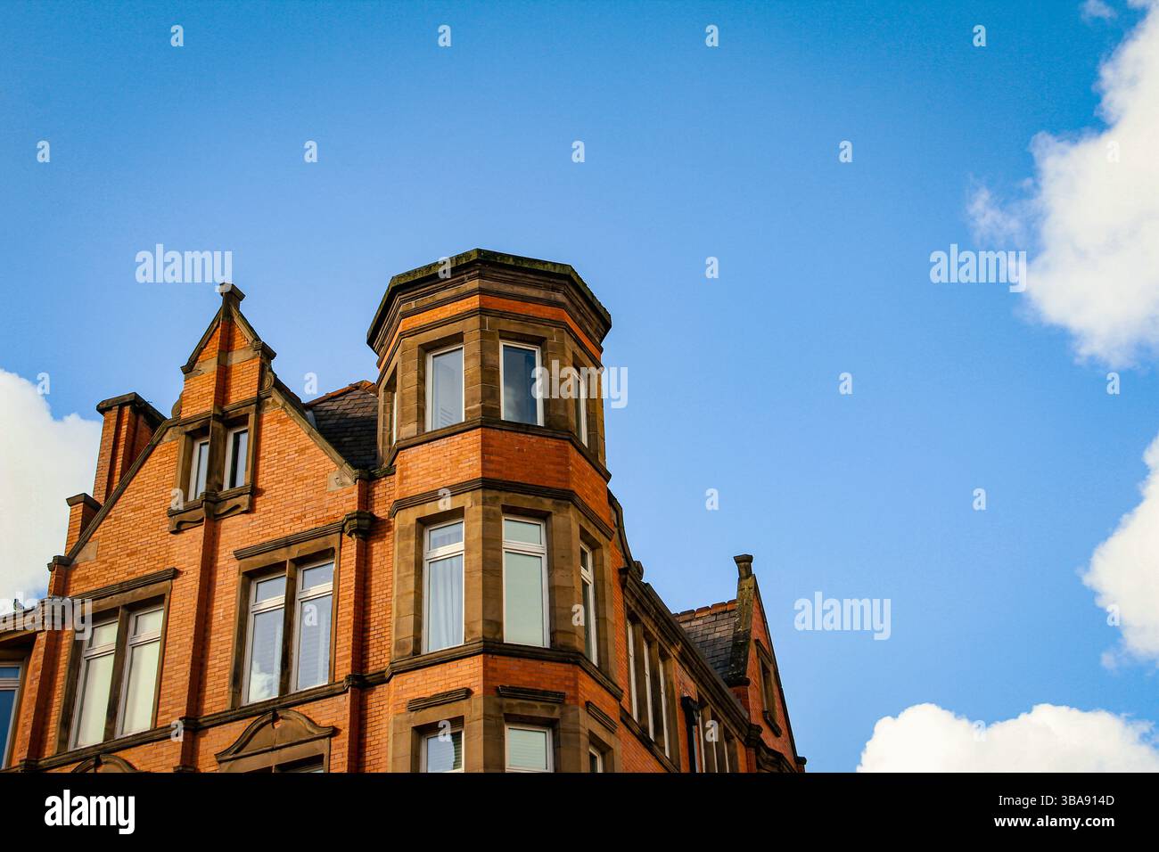 Brick tower topped with a cupola, set against a vivid sky in a historic ...