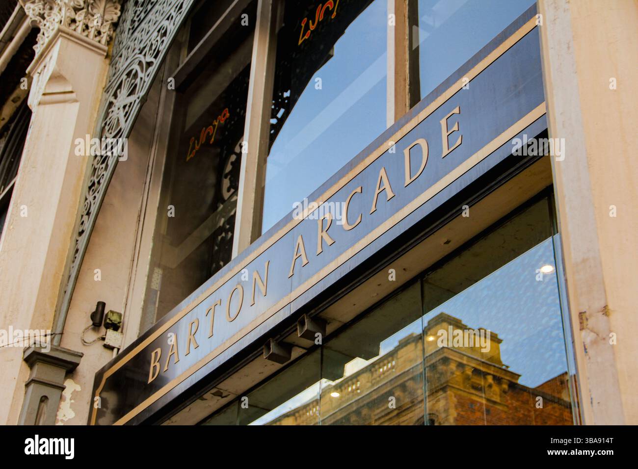 Golden signage reading "Royal Arcade" above a glass doorway, capturing ...