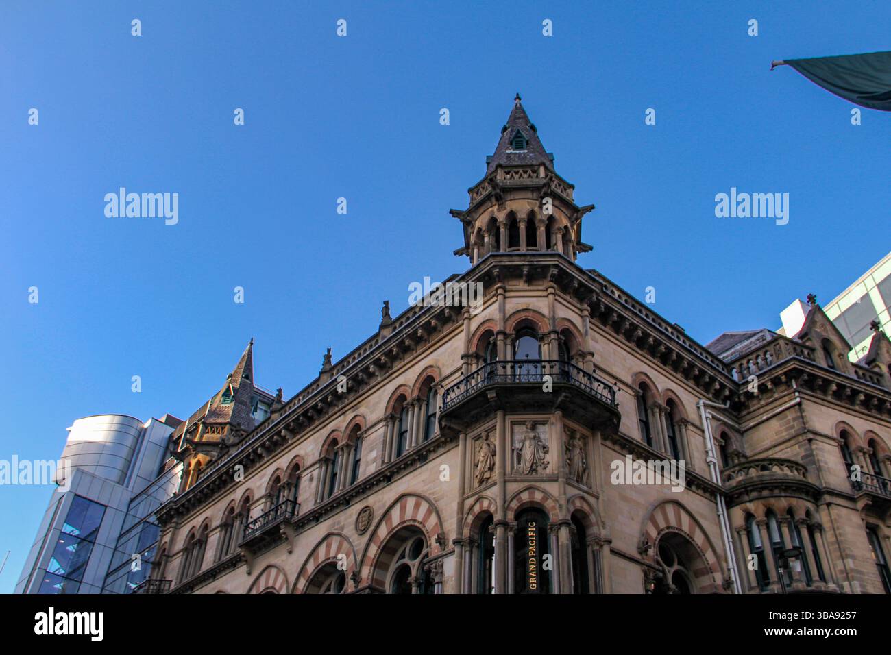 Grand facade of a neo-gothic building with spires and arched windows ...