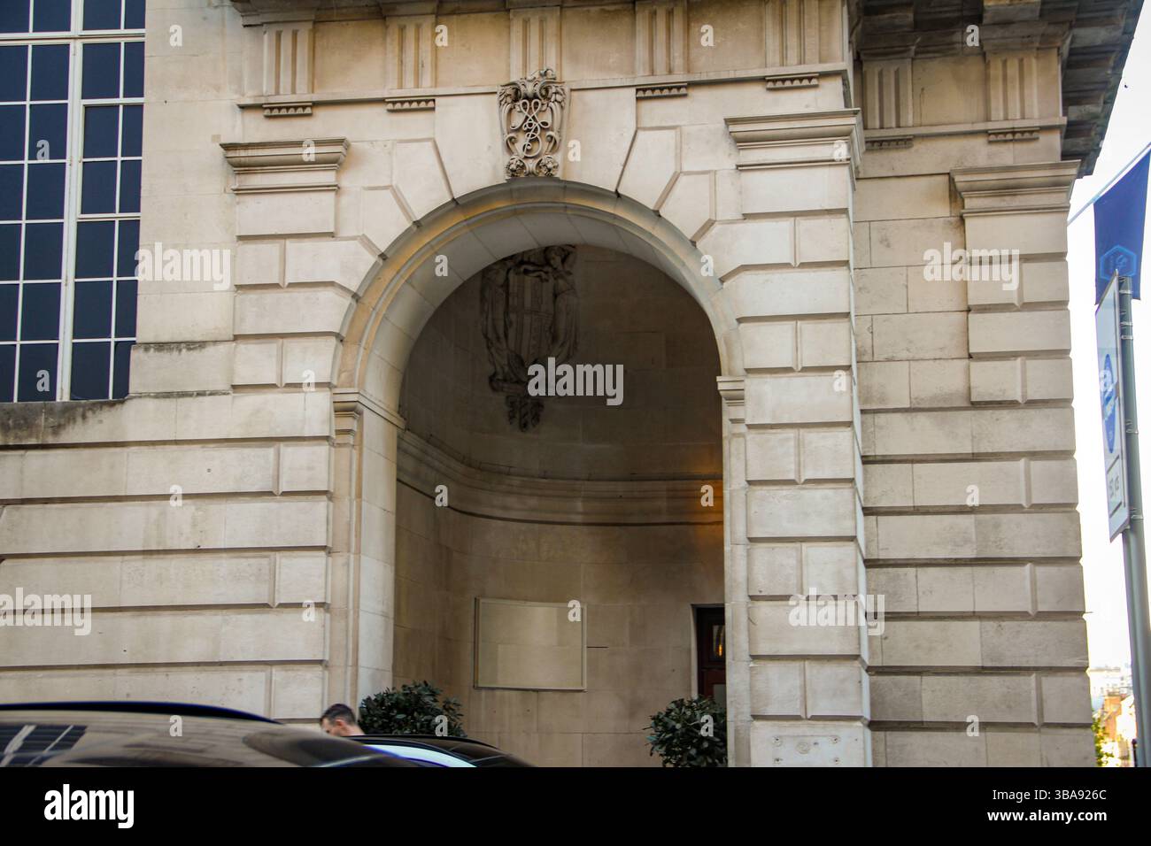 Grand facade of a neo-gothic building with spires and arched windows ...