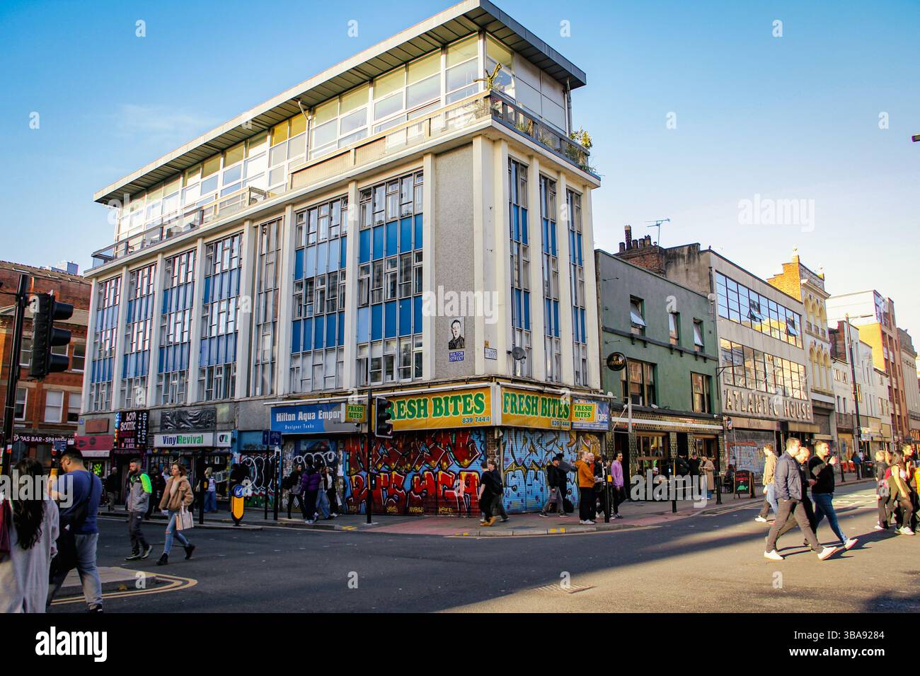 Art Deco-style building with white cladding and retail signs on a ...