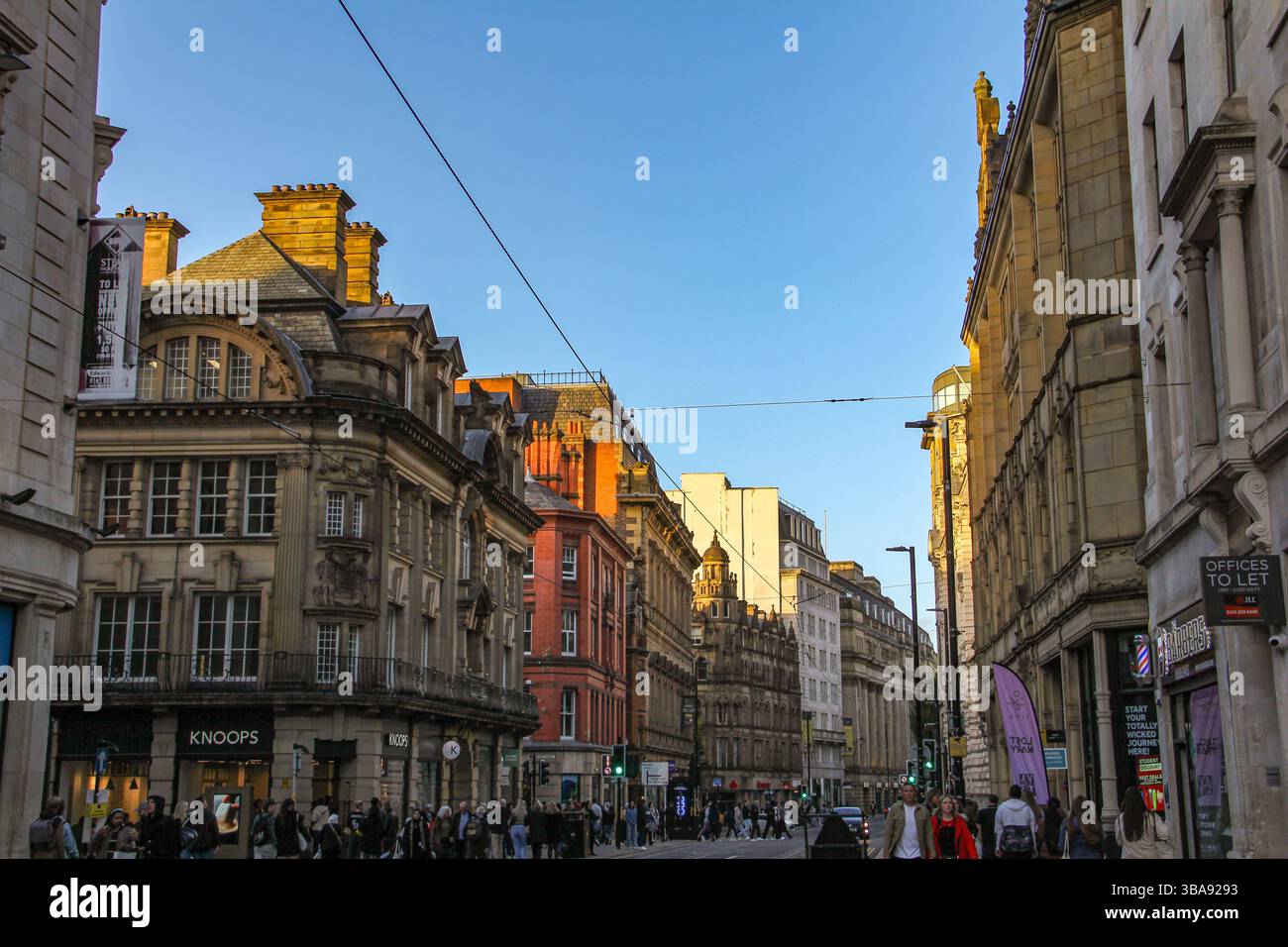Cross St, A deep street view of ornate historic buildings under a ...