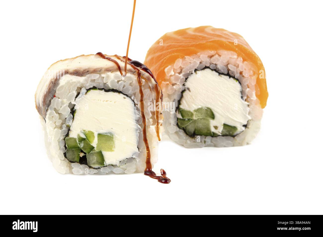 Japanese sushi rolls with eel and red fish sprinkled with soy sauce ...