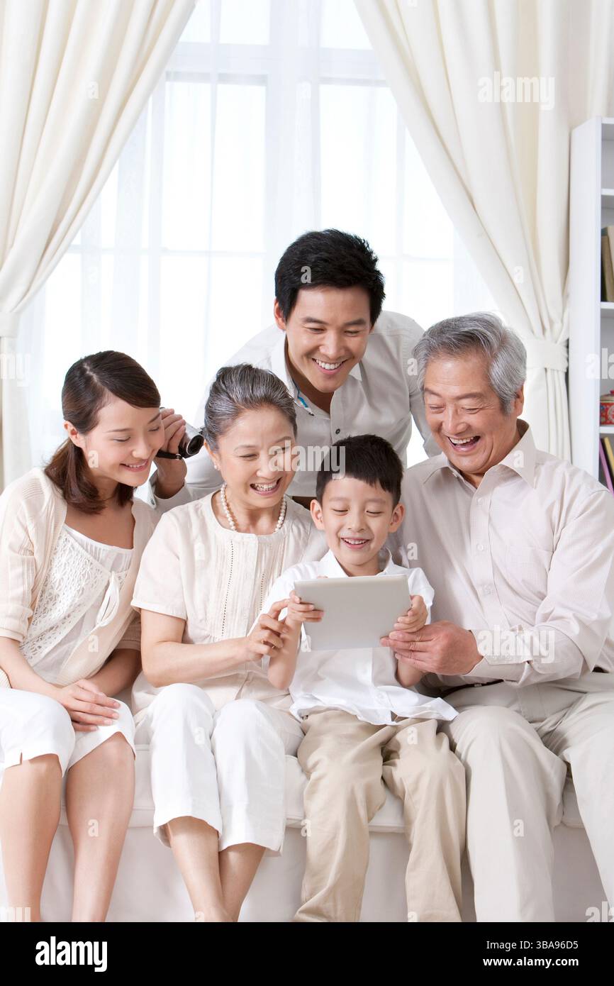 Happy Chinese family using an ipad together Stock Photo - Alamy