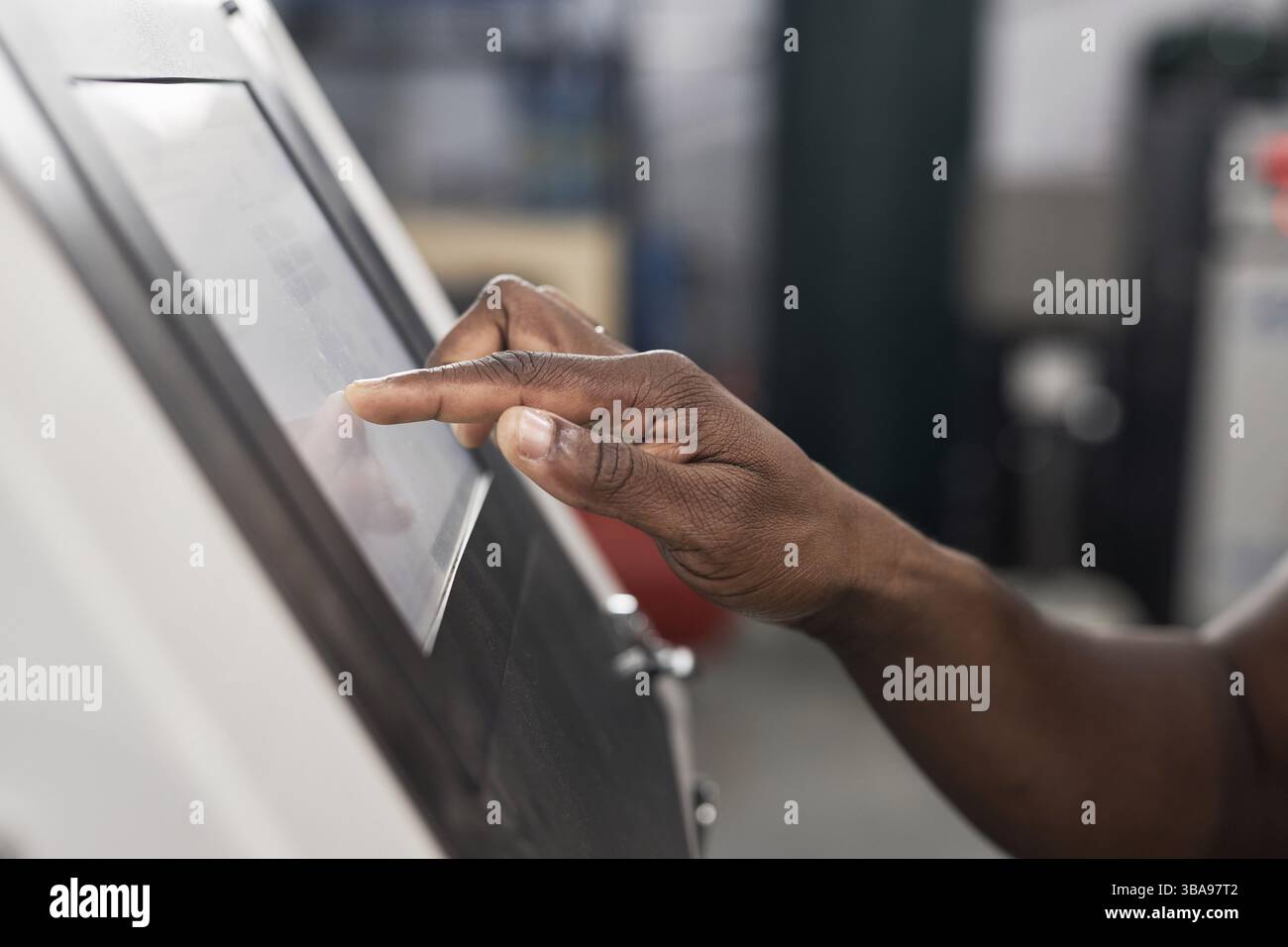 Side view closeup of male hand operating touch screen control panel and ...