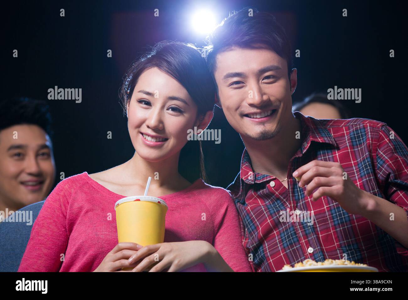 Young Chinese couple watching movie in cinema Stock Photo - Alamy