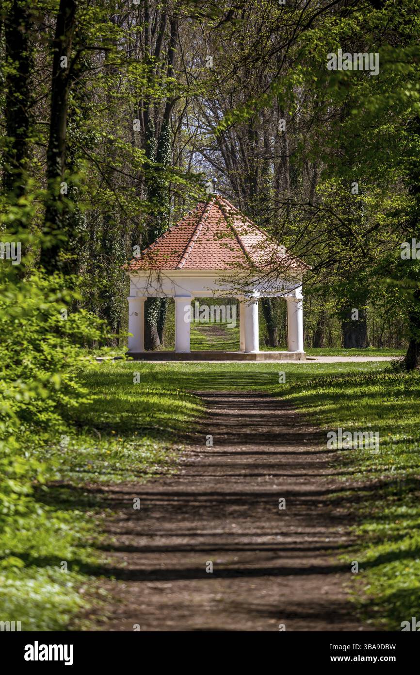 Old trees, gazebo and ruins of old chapel in English park of baroque ...