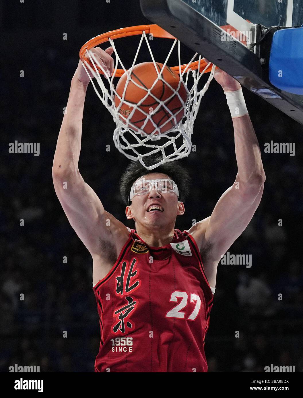Beijing, China. 12th May, 2025. Zhou Qi of Beijing Ducks dunks during ...