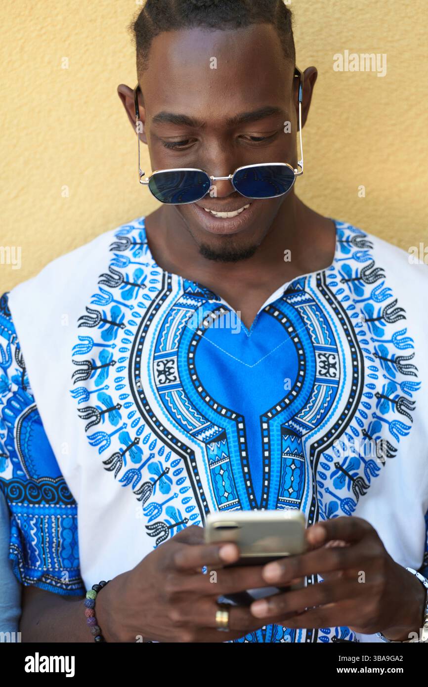 Native Sudan black african man using smart phone and wearing ...