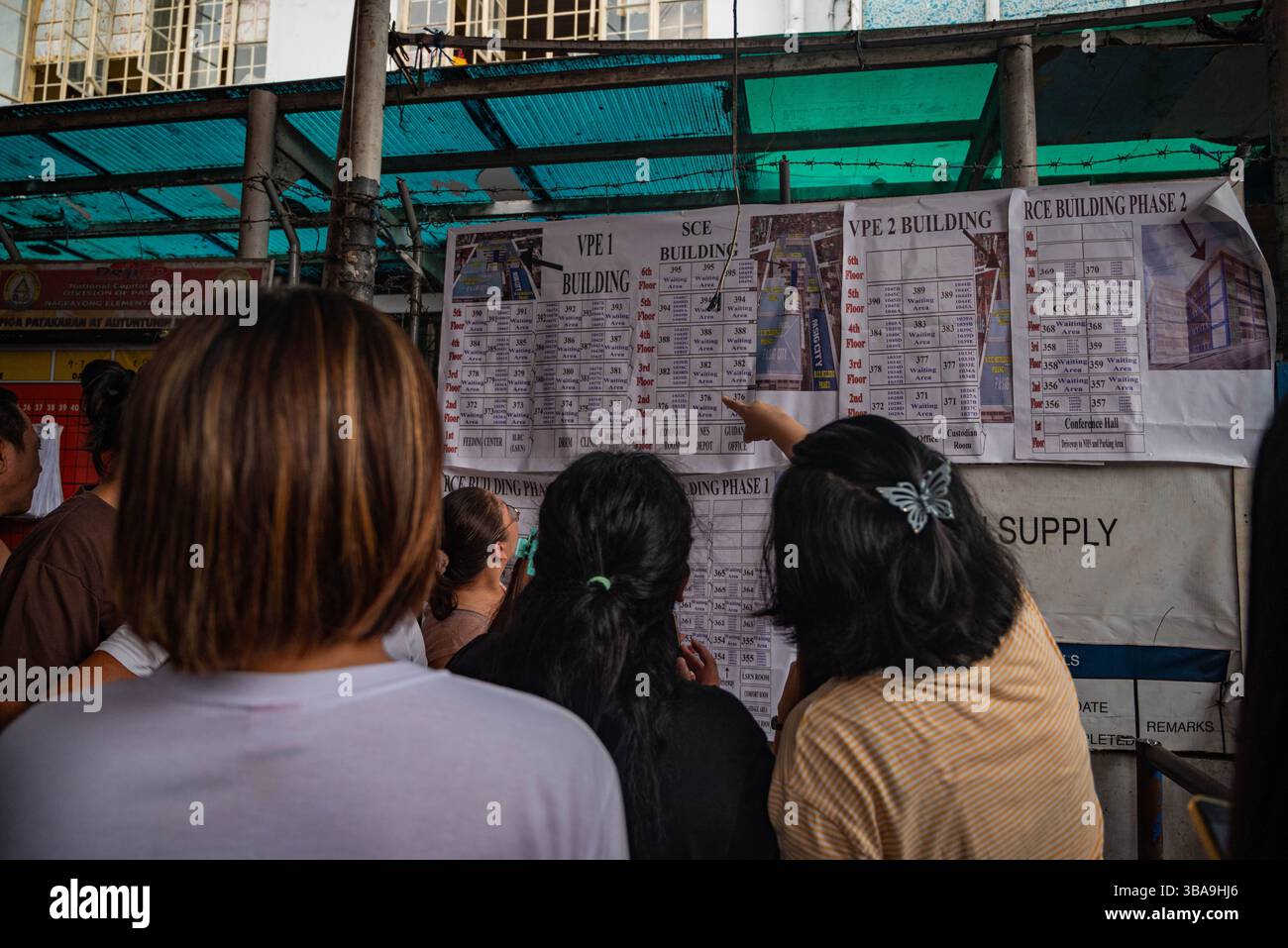 May 12, 2025, Quezon City, Quezon, Philippines: Voters look at the map ...