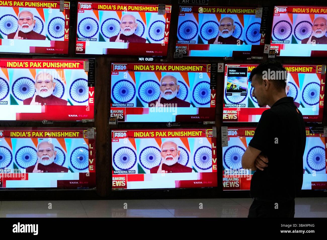 A man watches the live telecast of Indian Prime Minister Narendra Modi ...