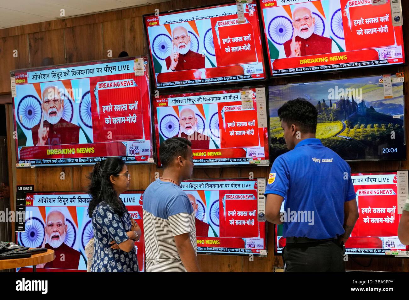 People watch the live telecast of Indian Prime Minister Narendra Modi's ...