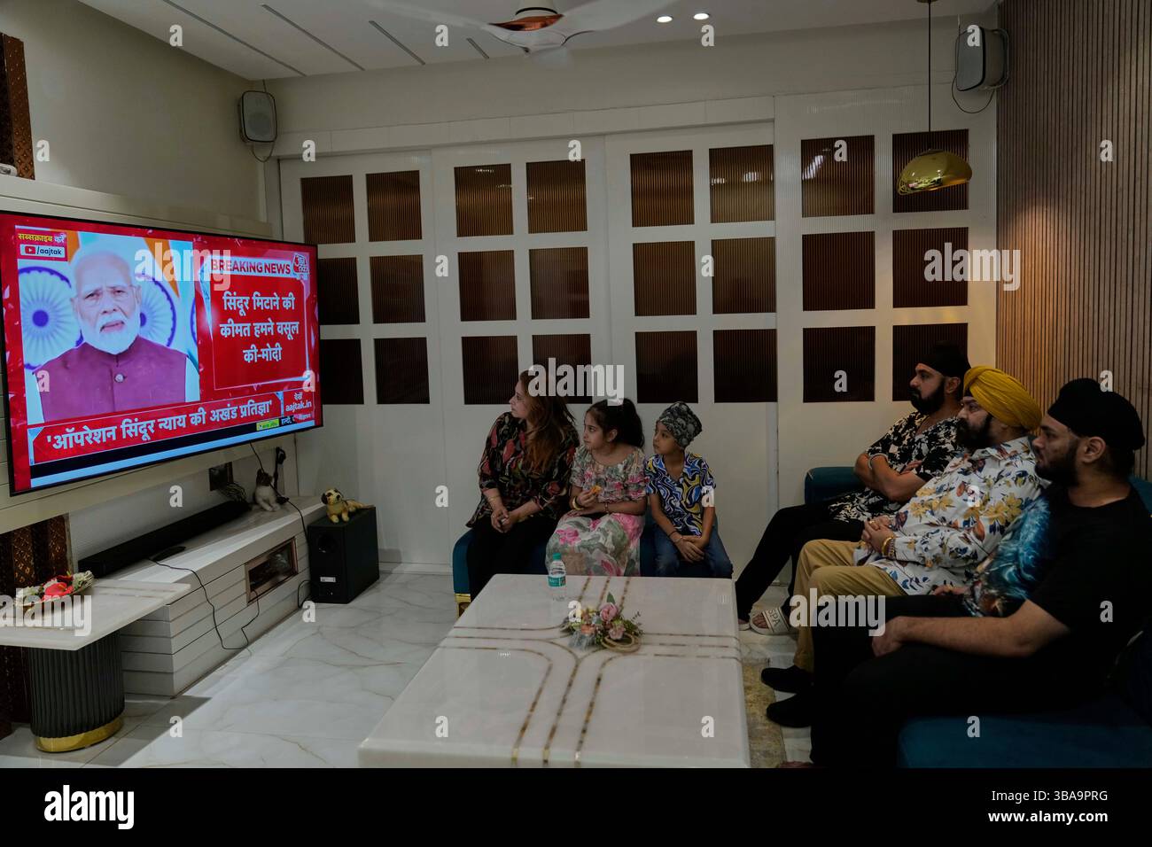 Family members watch the live telecast of Indian Prime Minister ...
